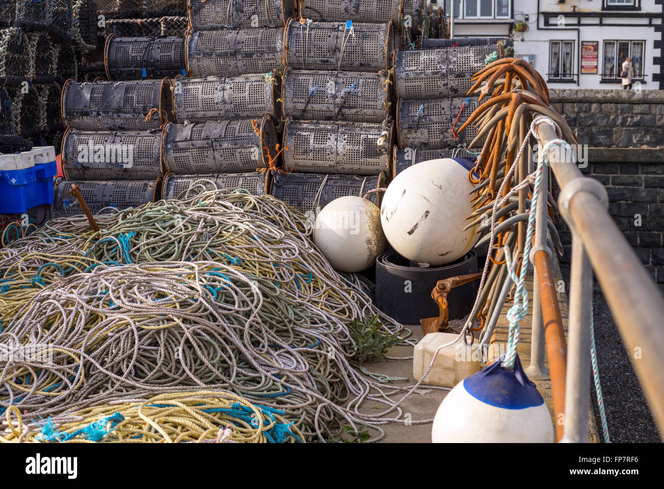 On the sea waters edge ropes, floats, lobster pots, and various sea ...