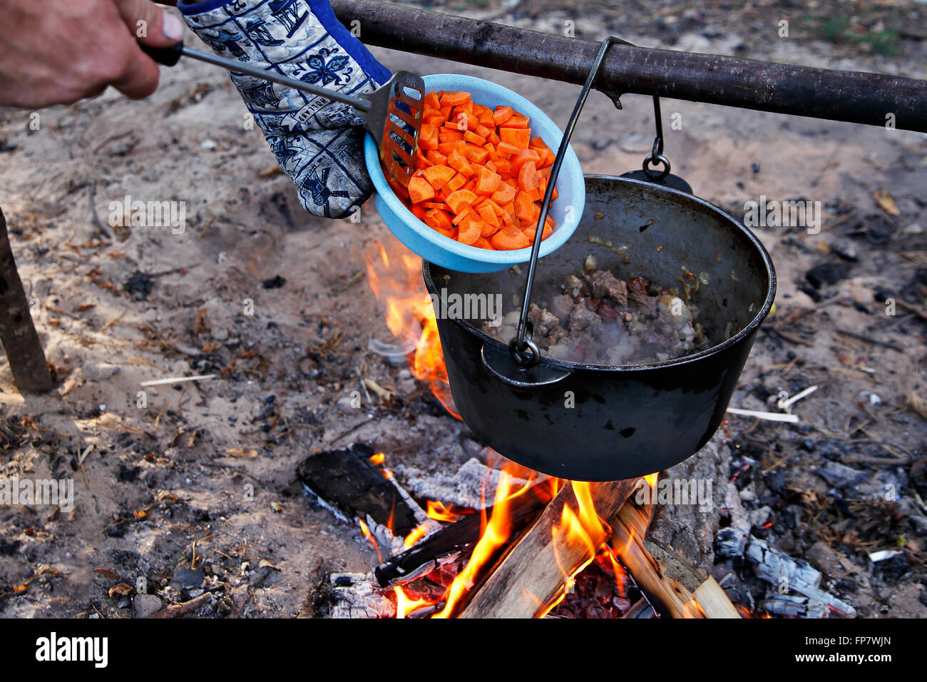 Outdoor cooking. Making food on a fire in a pot Stock Photo - Alamy