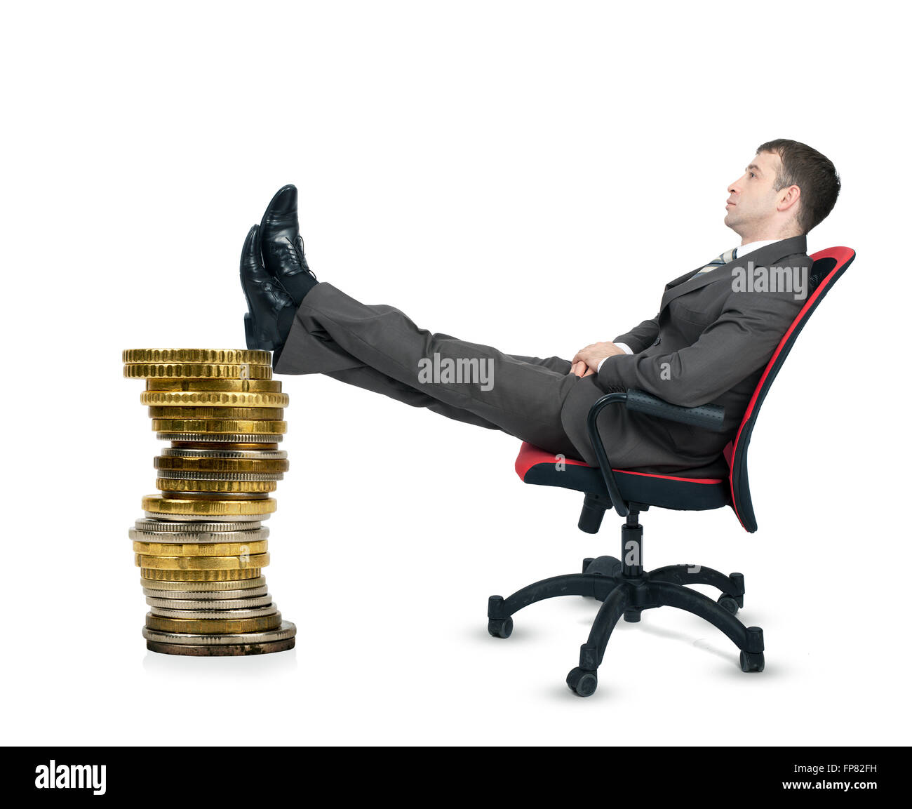 Businessman sitting on chair with legs on coins isolated on white ...