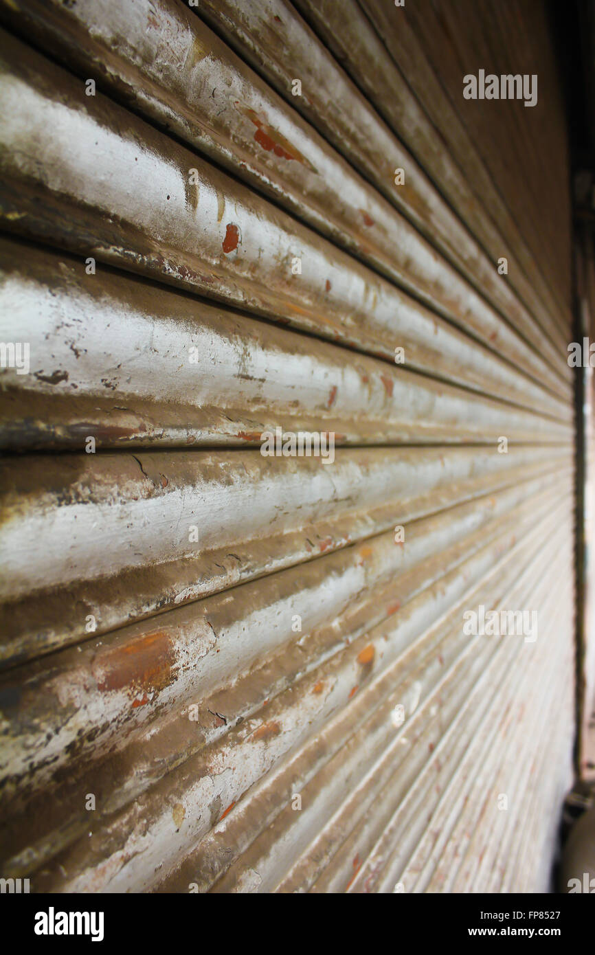 Side view of grunge metallic roller closed shutter of shop Stock Photo ...