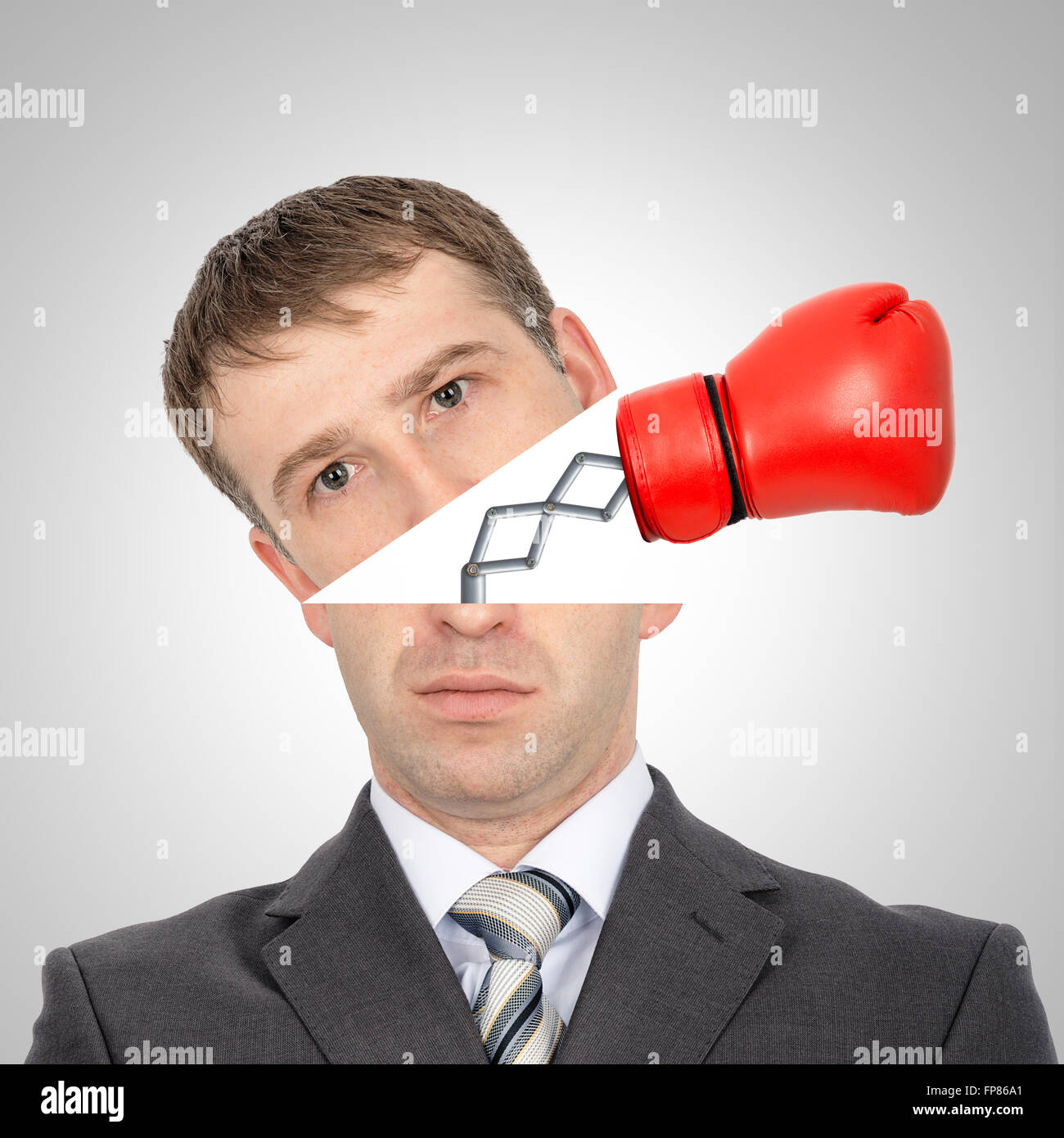 Boxing glove beating from businessmans head on grey background, closeup ...