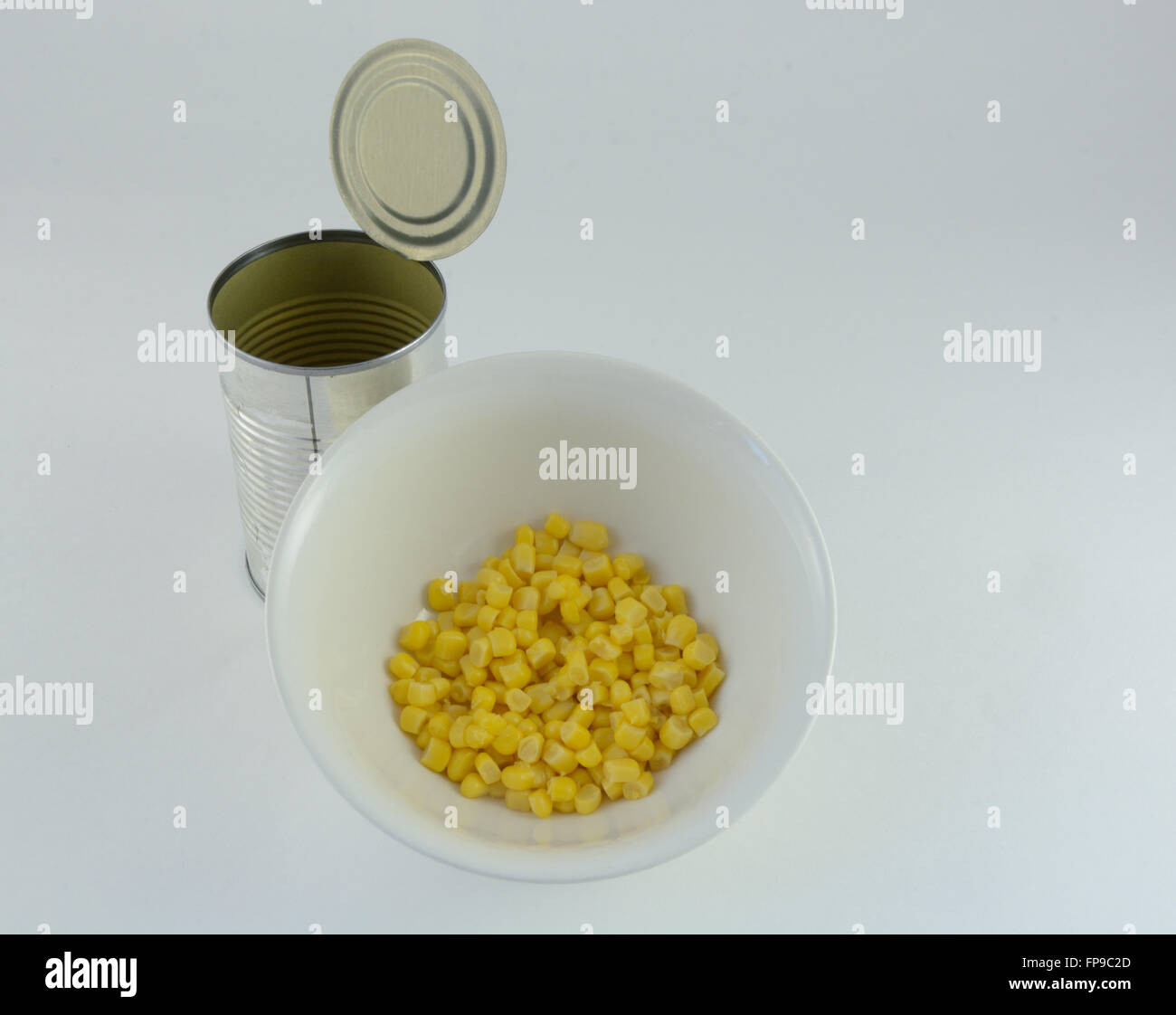 Canned corn in bowl with empty can Stock Photo - Alamy