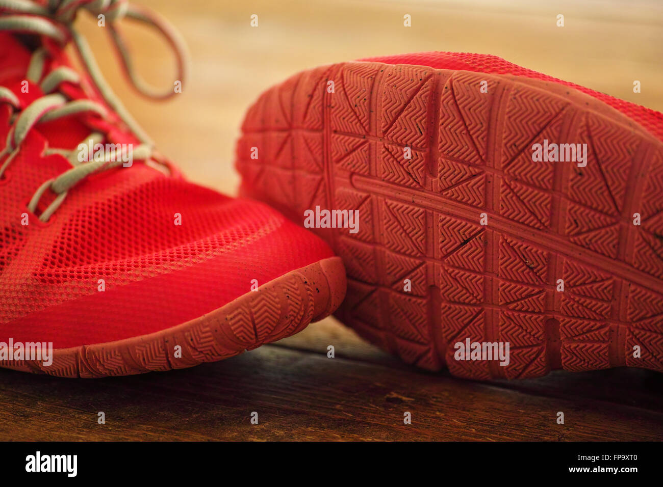 Pink ladies Nike trainer exercise shoes on wooden floor boards Stock ...