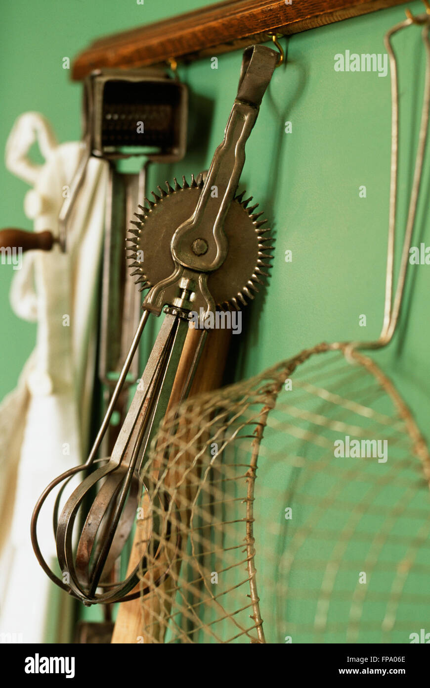 Vintage Kitchen Gadgets Hanging from a Rack Stock Photo - Alamy