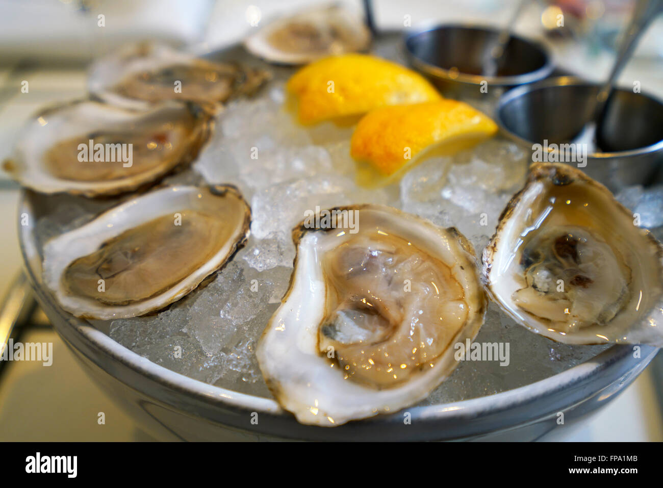 Raw oysters served on the half shell over ice in a seafood restaurant ...