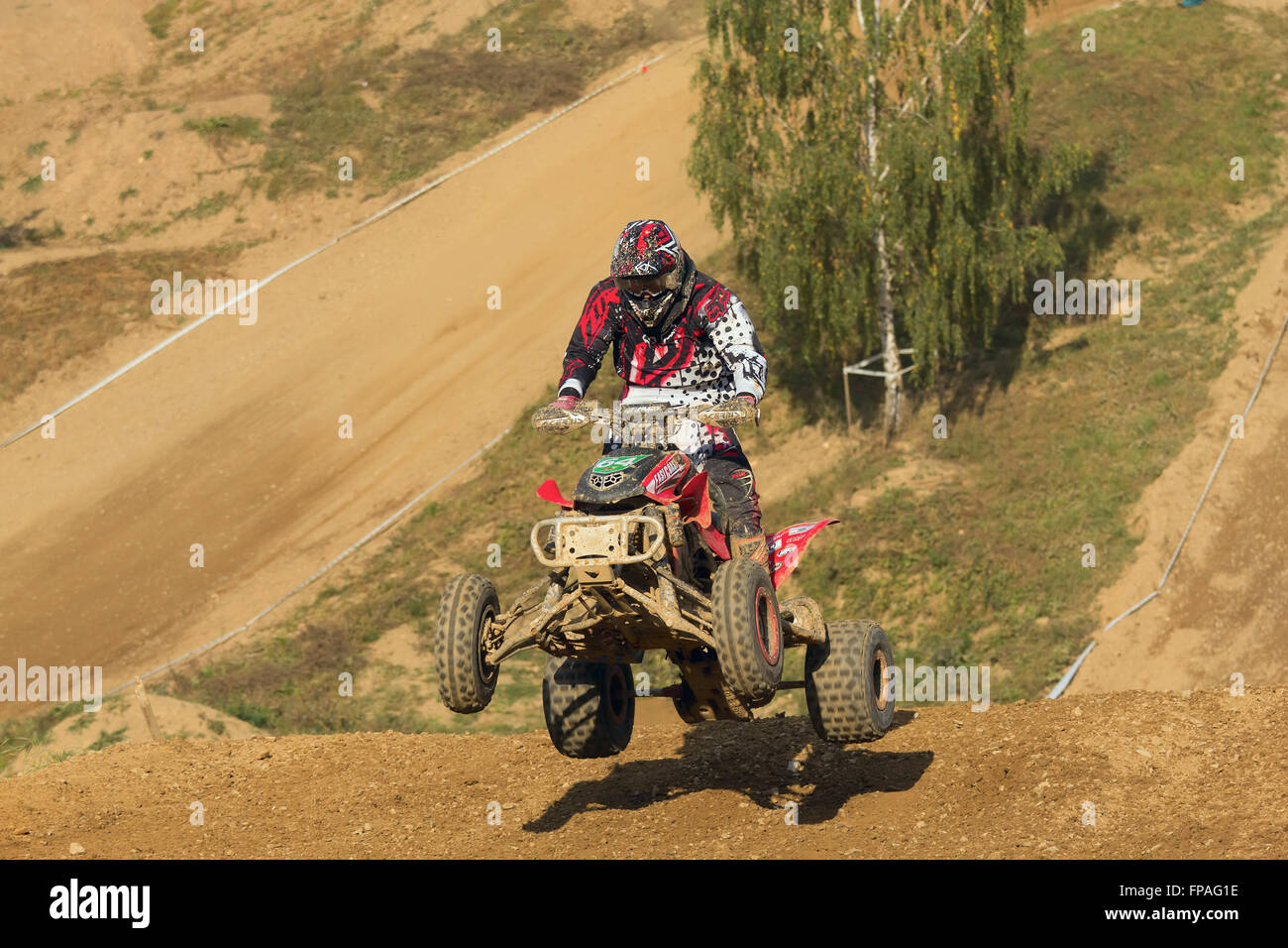 Quad racer is jumping with a quad motorbike in the race Stock Photo - Alamy