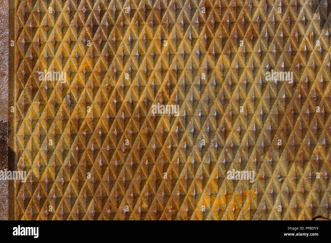 Close-up of waffle textured metal grid on sidewalk Stock Photo - Alamy