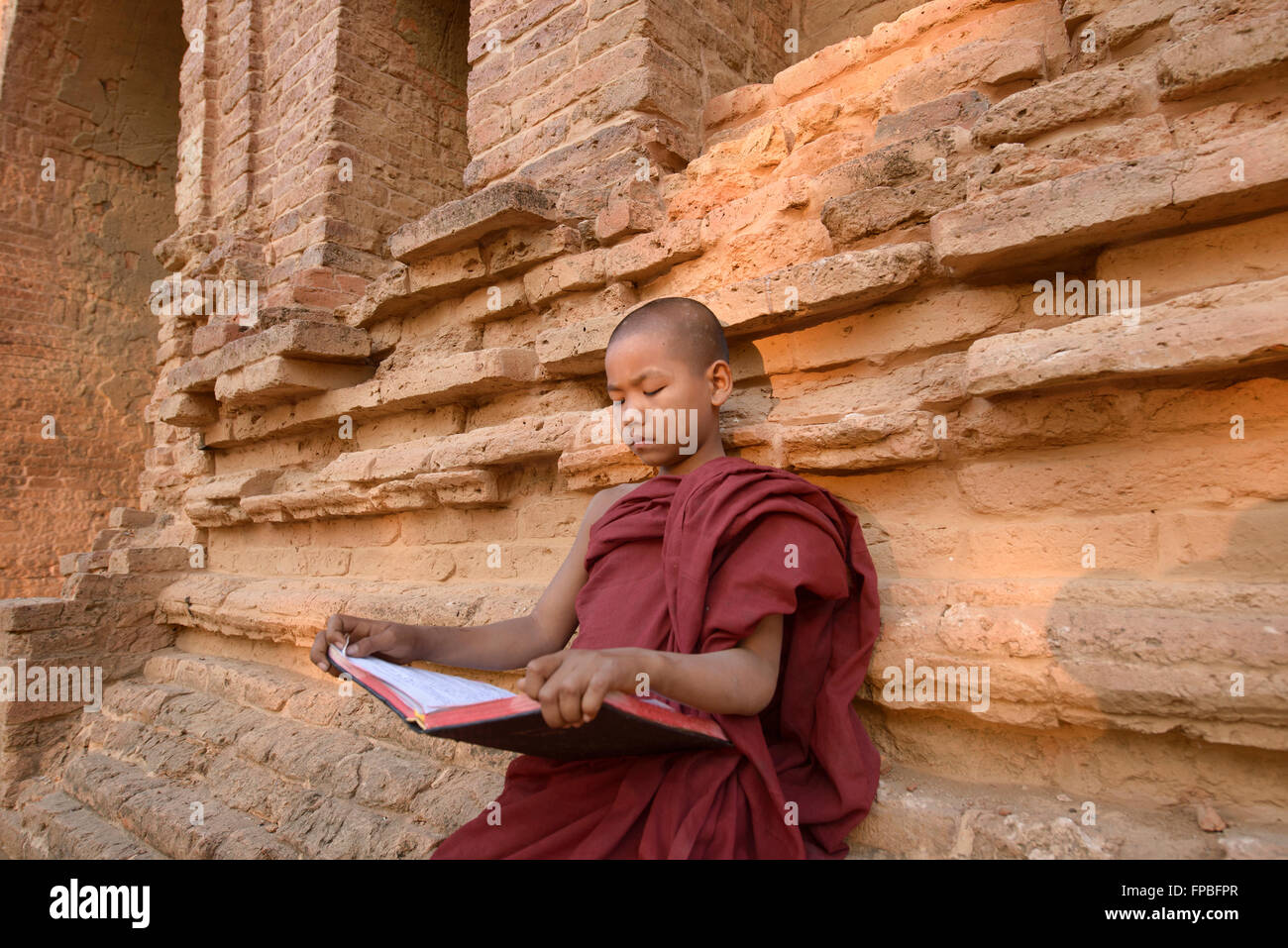 A young buddhist monk reading hi-res stock photography and images - Alamy