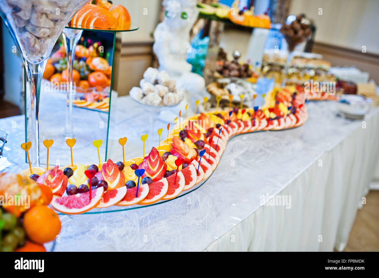 Wedding reception of fruits, decorated grapefruit apple and grape Stock ...