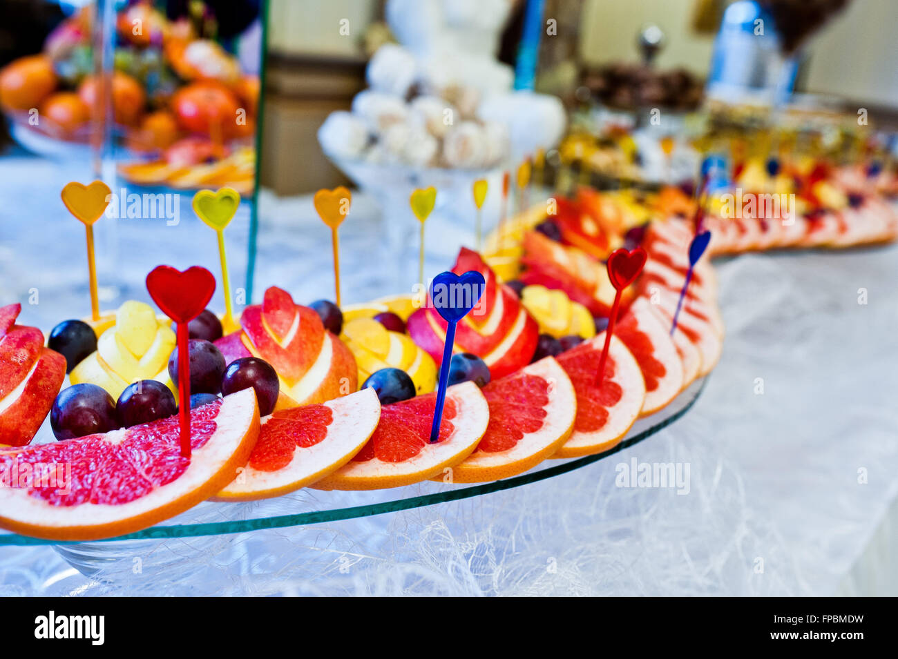 Wedding reception of fruits, decorated grapefruit apple and grape Stock ...
