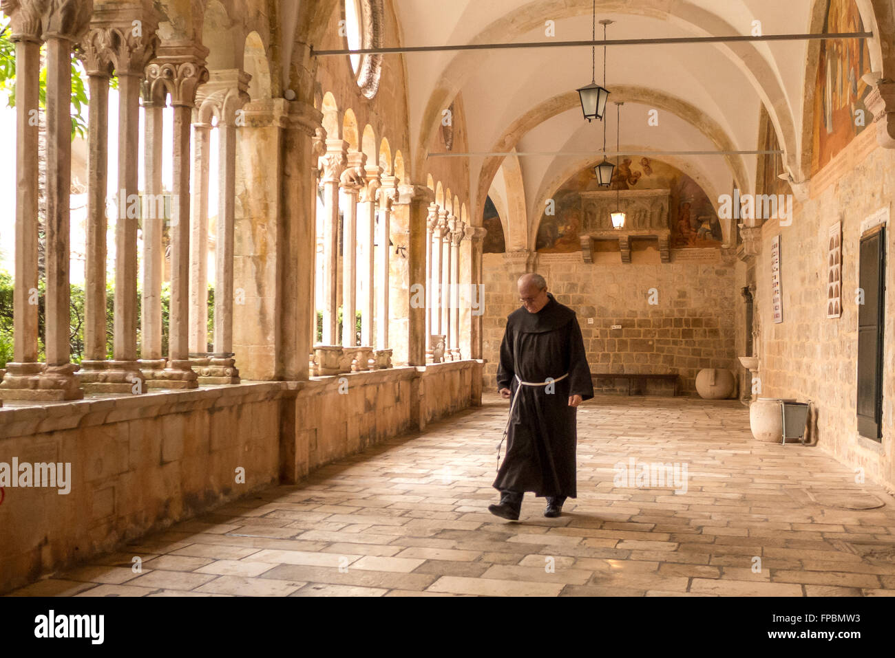 A monk inside the cloisters of the Franciscan Monastery in Dubrovnik ...
