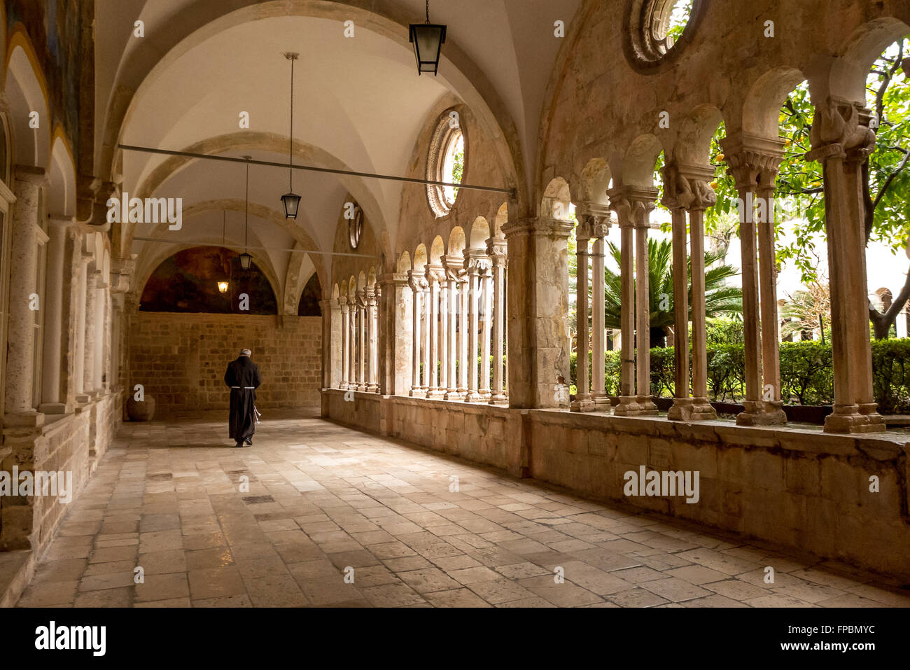 A monk inside the cloisters of the Franciscan Monastery in Dubrovnik ...
