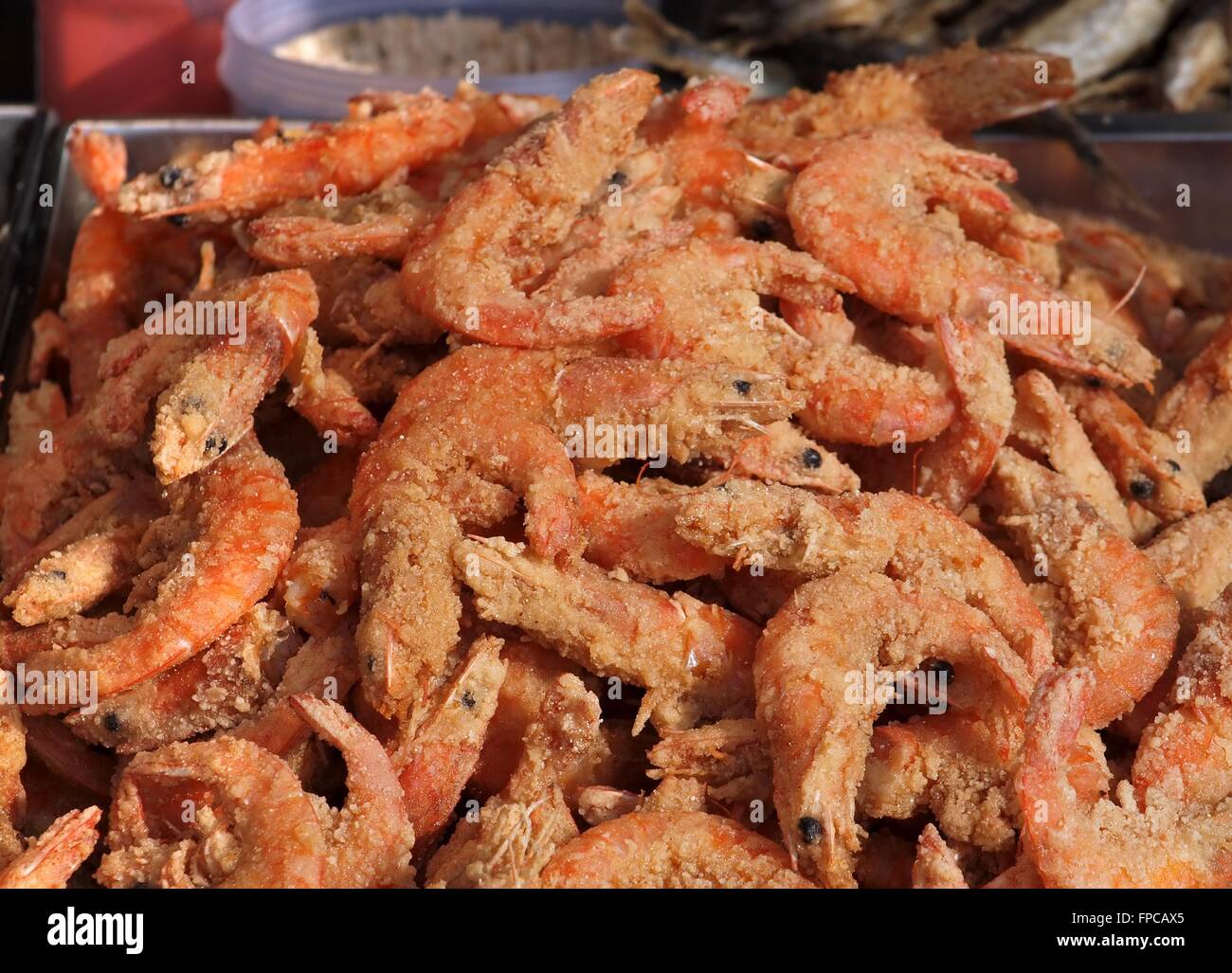 A large pile of deep fried shrimps at an outdoor food stall Stock Photo ...