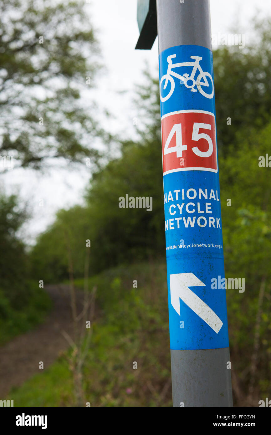 A highway or roadside sign with a sticker placed on it indicating the ...
