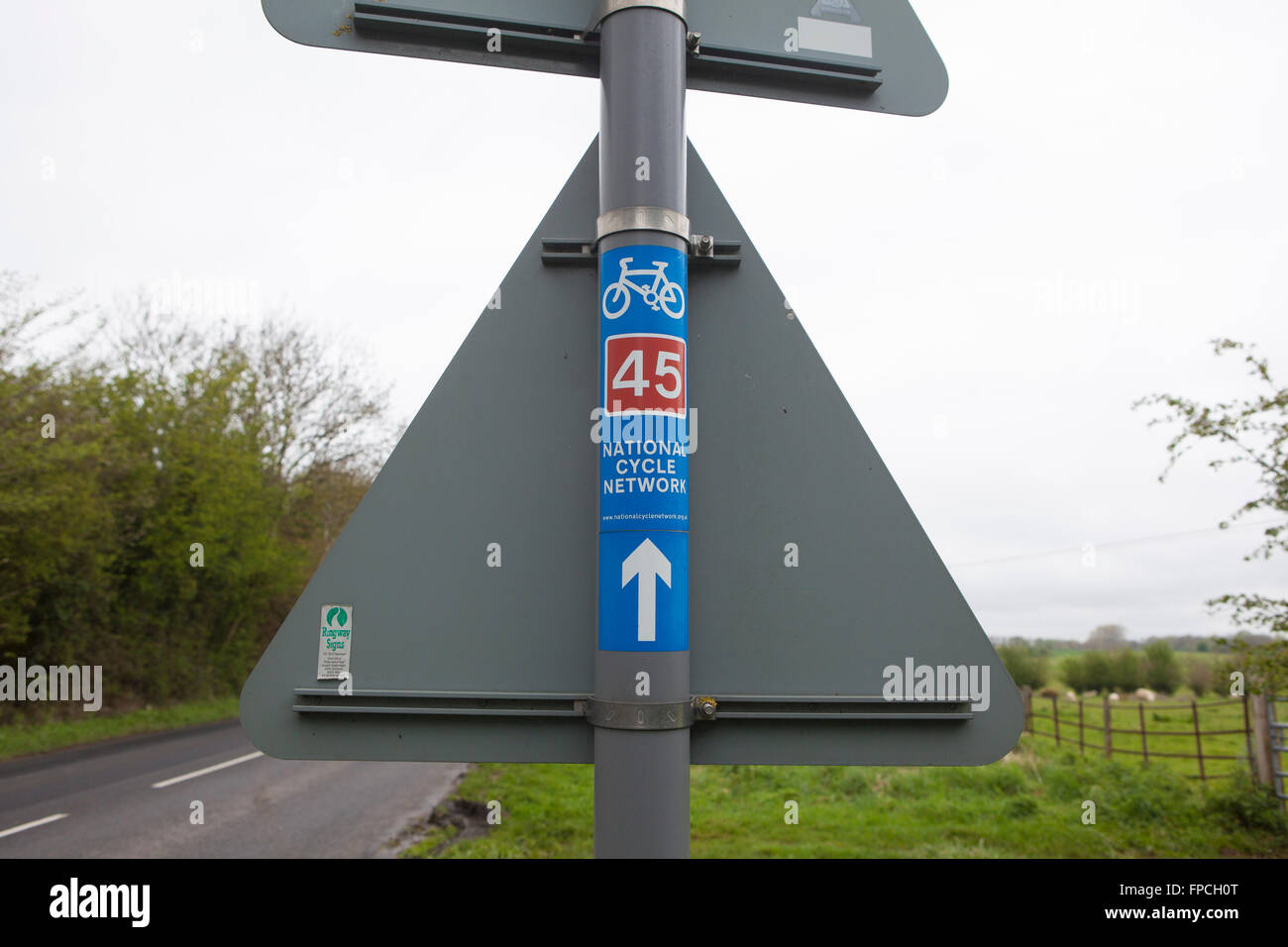 A highway or roadside sign with a sticker placed on it indicating the ...