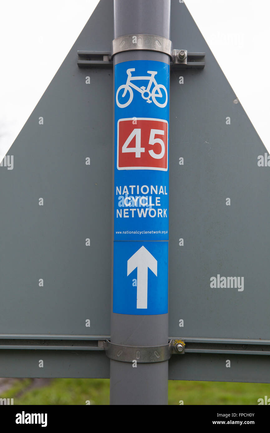 A highway or roadside sign with a sticker placed on it indicating the ...
