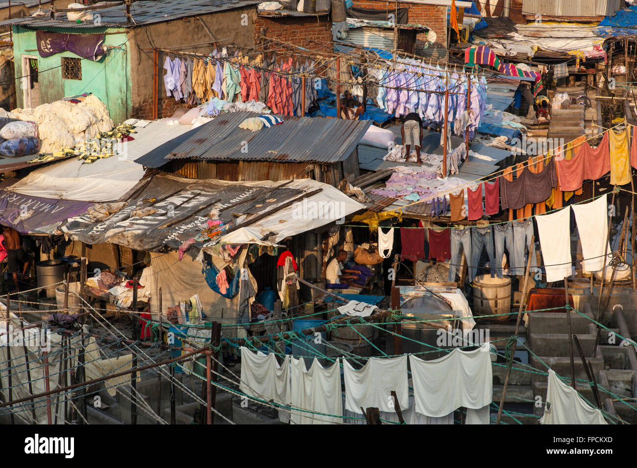 A view from above of a slum in Mumbai in India. People can be seen ...