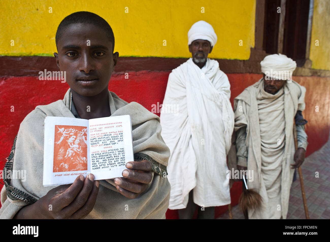 An orthodox christian religious student is showing his prayer book ...