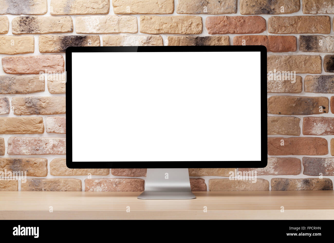 Office desk workplace with pc in front of brick wall. Loft style Stock ...