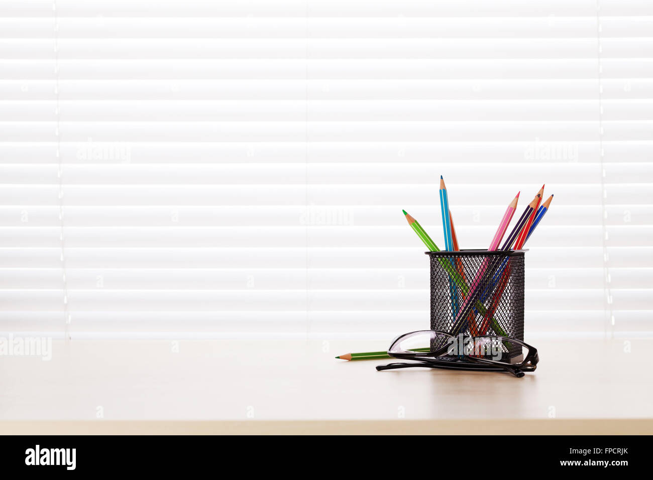 Office workplace with supplies on wood desk table in front of window ...