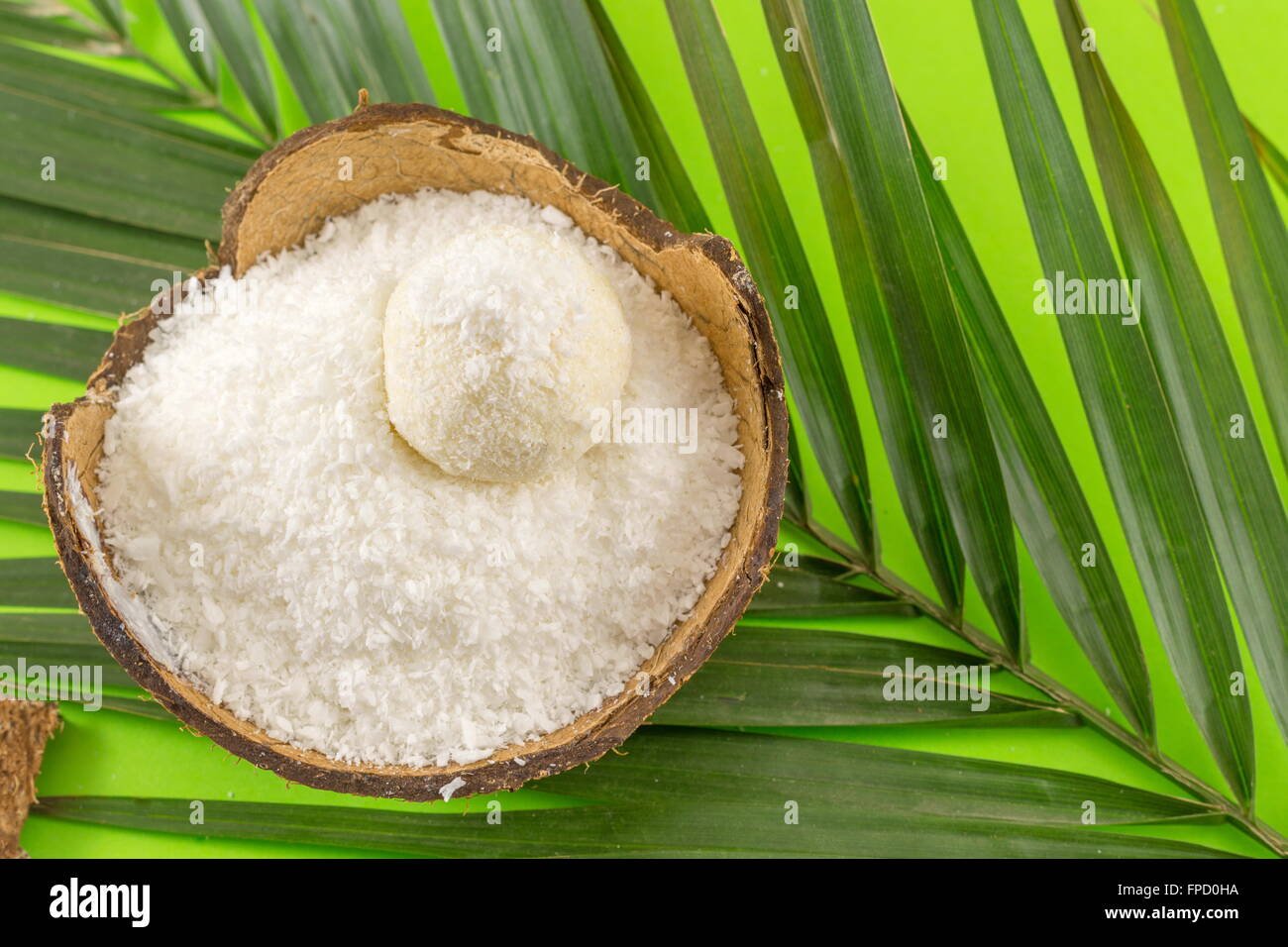Coconut powder and dessert in coconut shell on green Stock Photo - Alamy