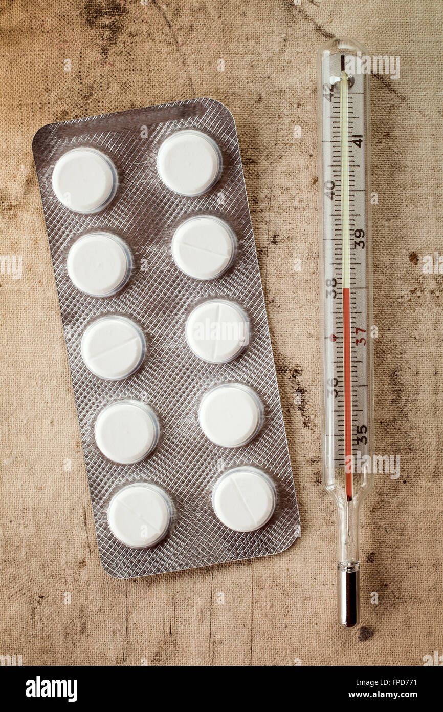 Medicaments with thermometer,which showing high temperature Stock Photo ...