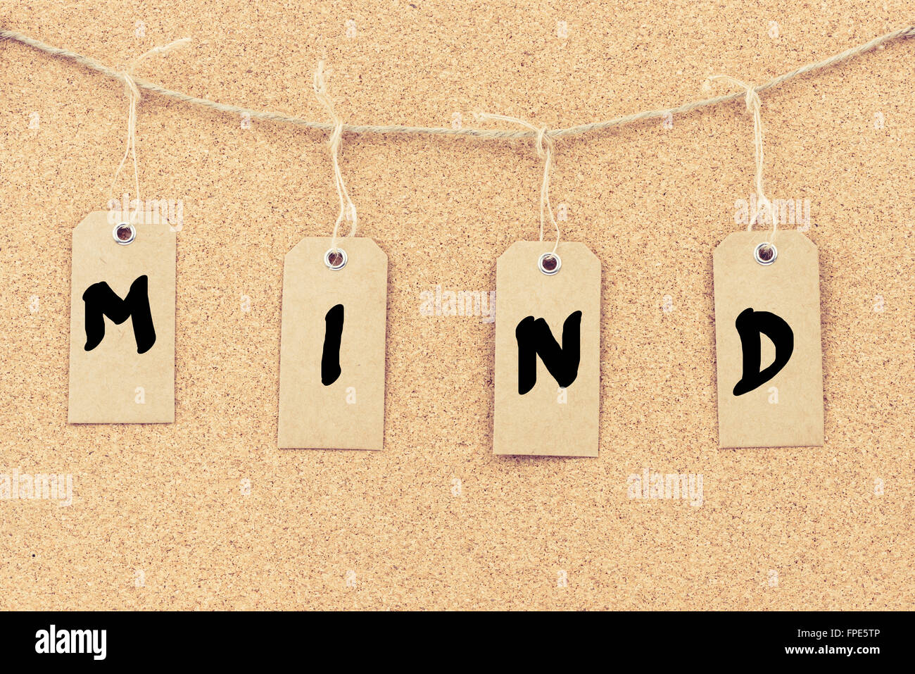 Vintage grunge tags with letters on rope string, word MIND over cork ...