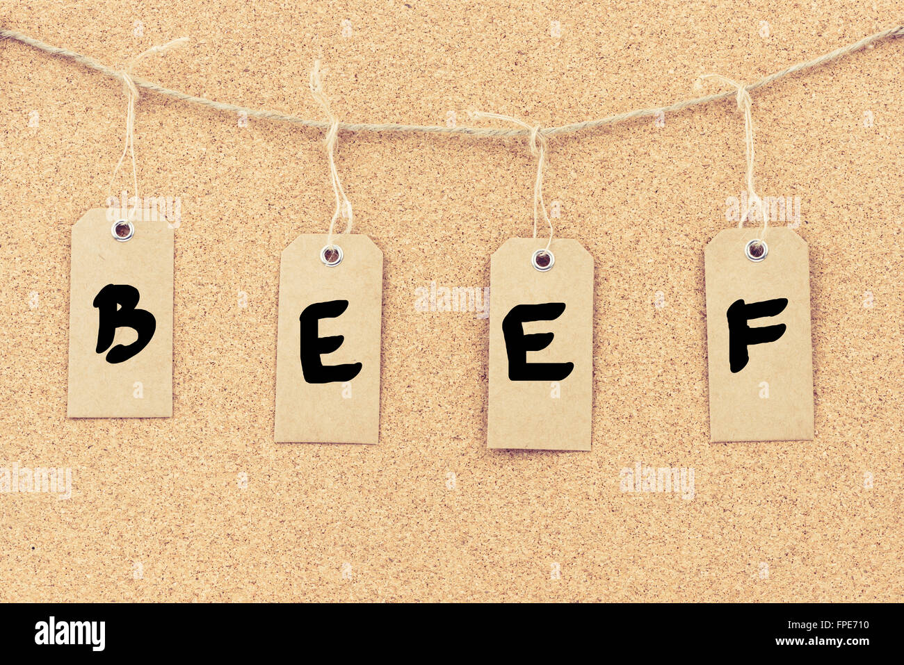 Vintage grunge tags with letters on rope string, word BEEF over cork ...