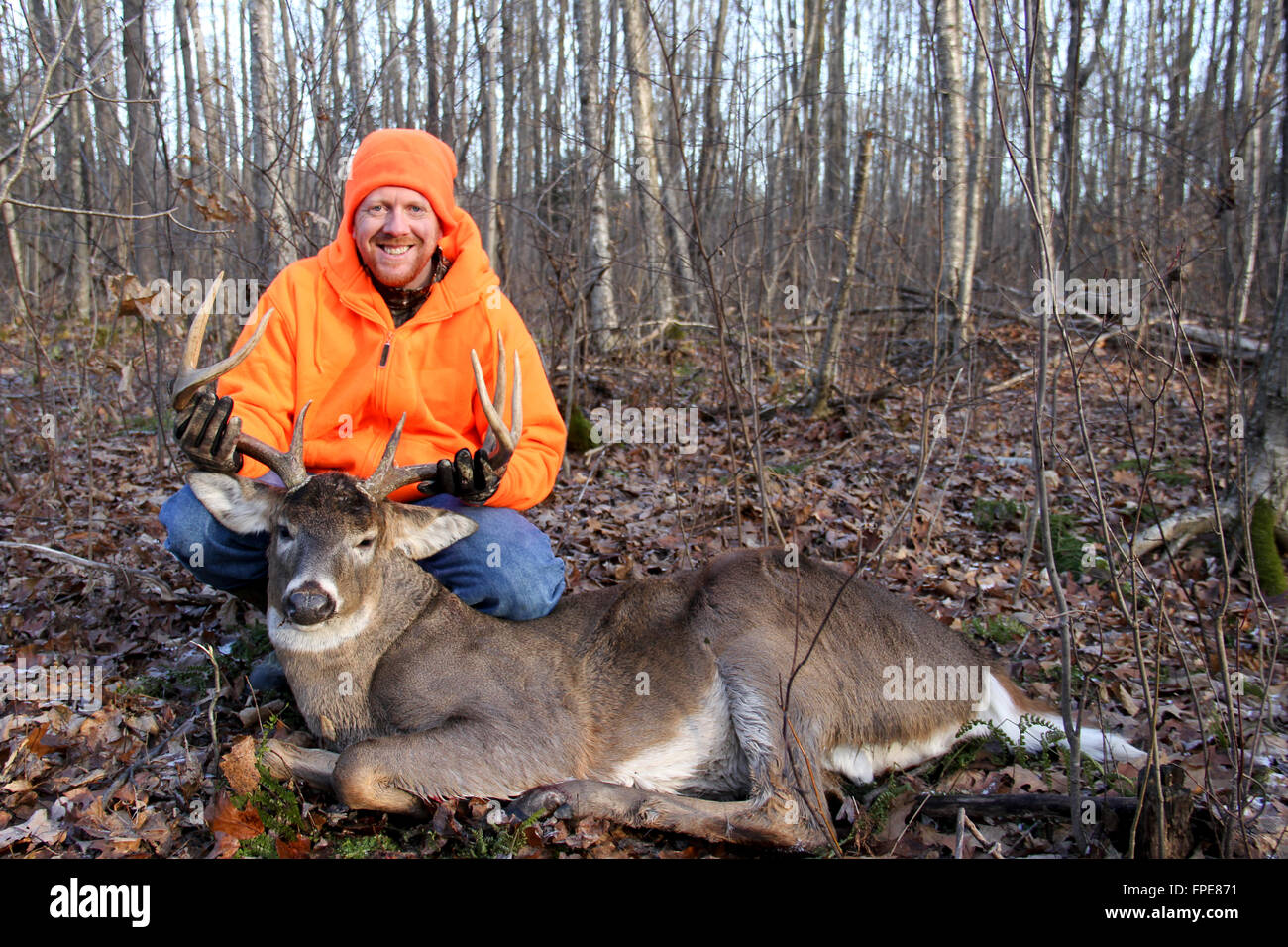 Hunter with a trophy whitetail buck he harvested during deer hunting ...