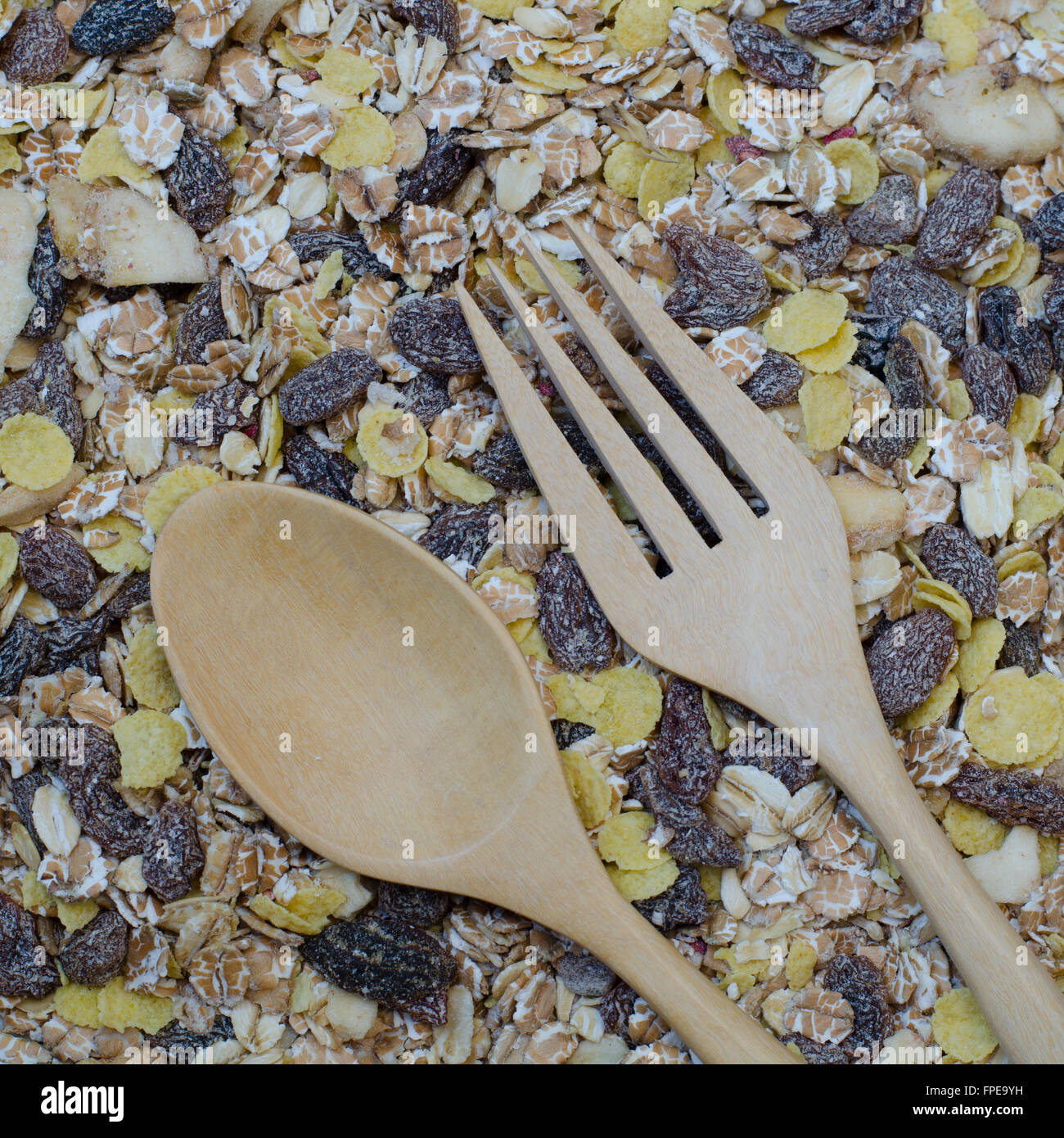 wooden fork and spoon on oat flakes background Stock Photo - Alamy