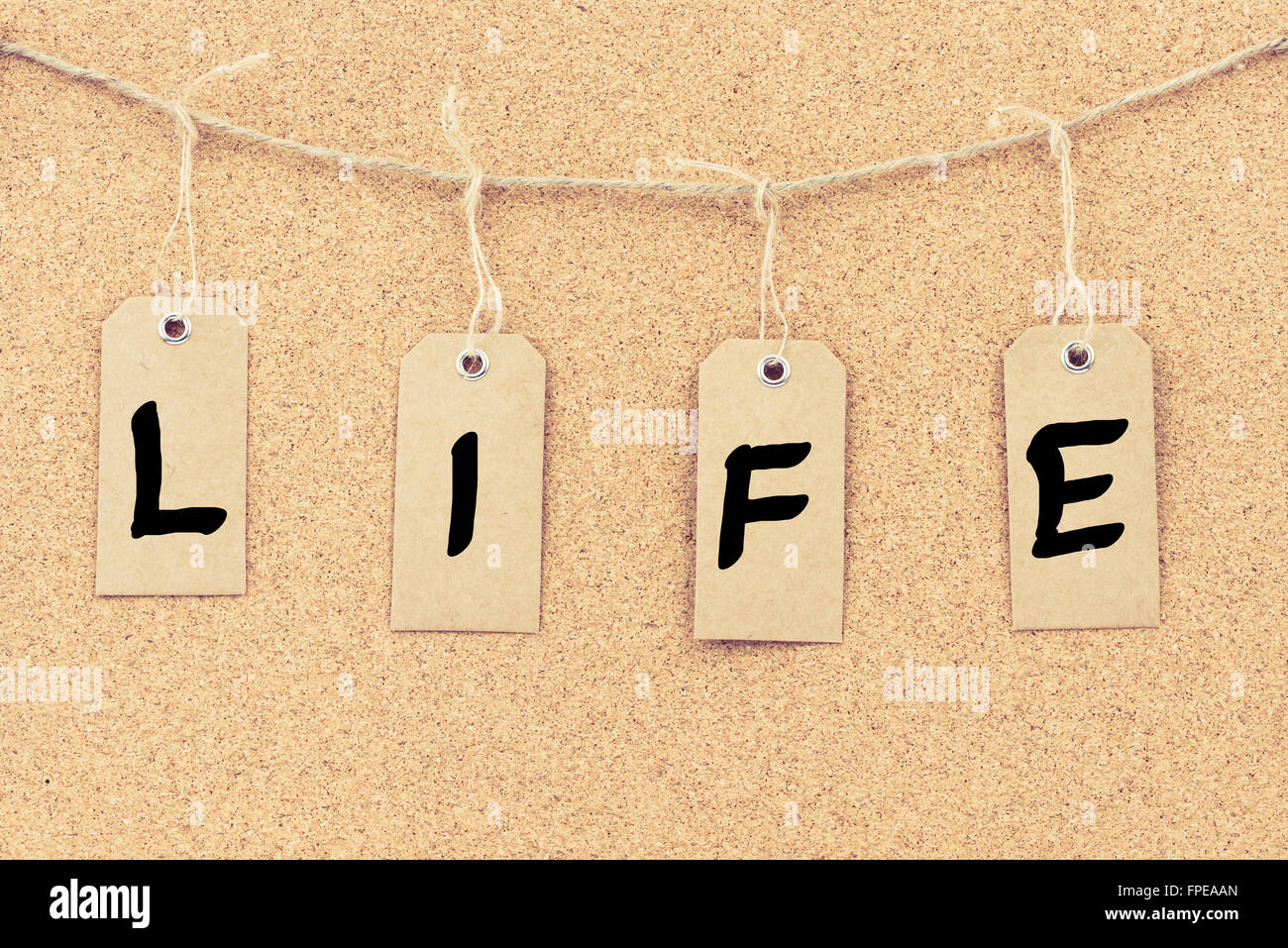 Vintage grunge tags with letters on rope string, word LIFE over cork ...