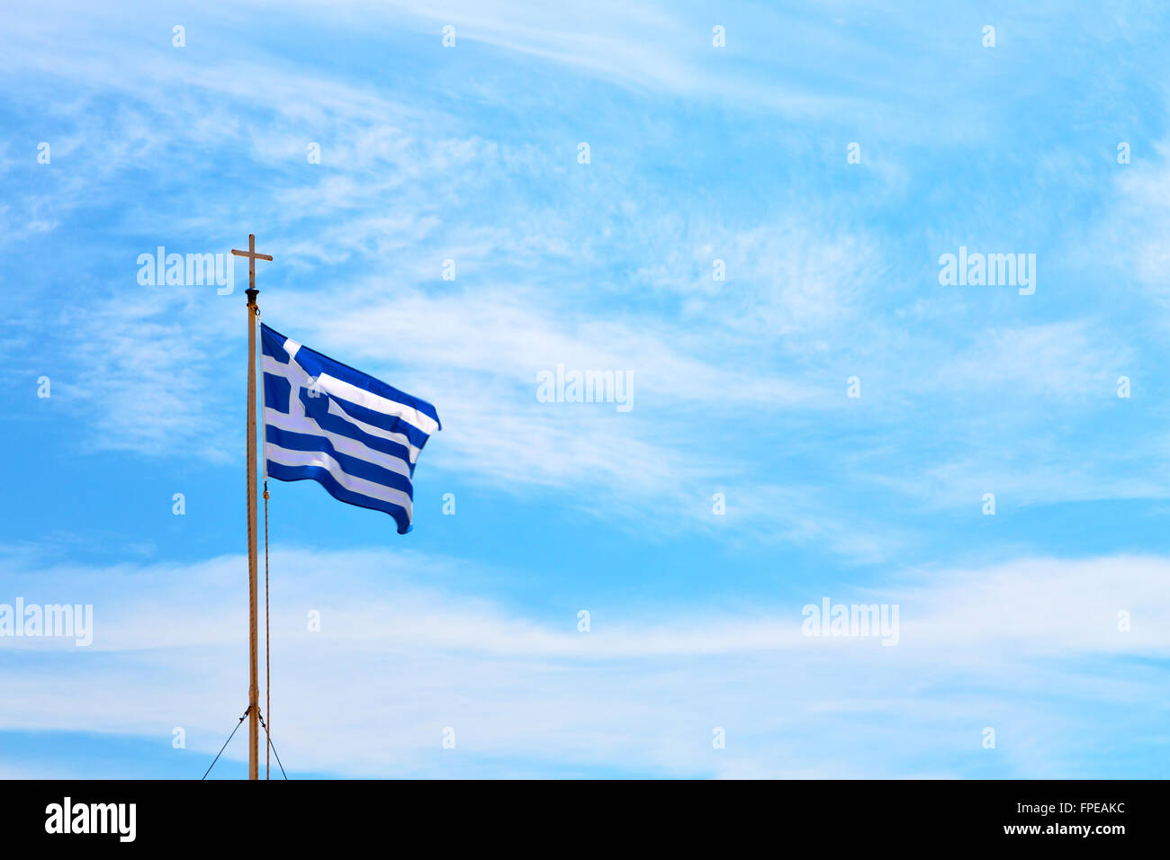 waving greece flag in the blue sky and flagpole Stock Photo - Alamy