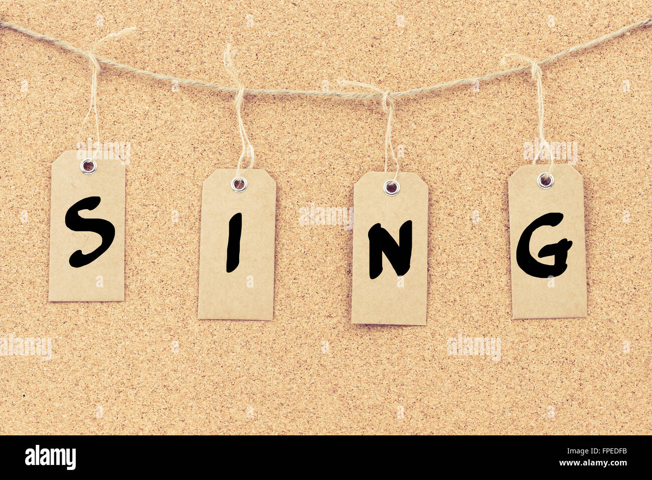 Vintage grunge tags with letters on rope string, word SING over cork ...