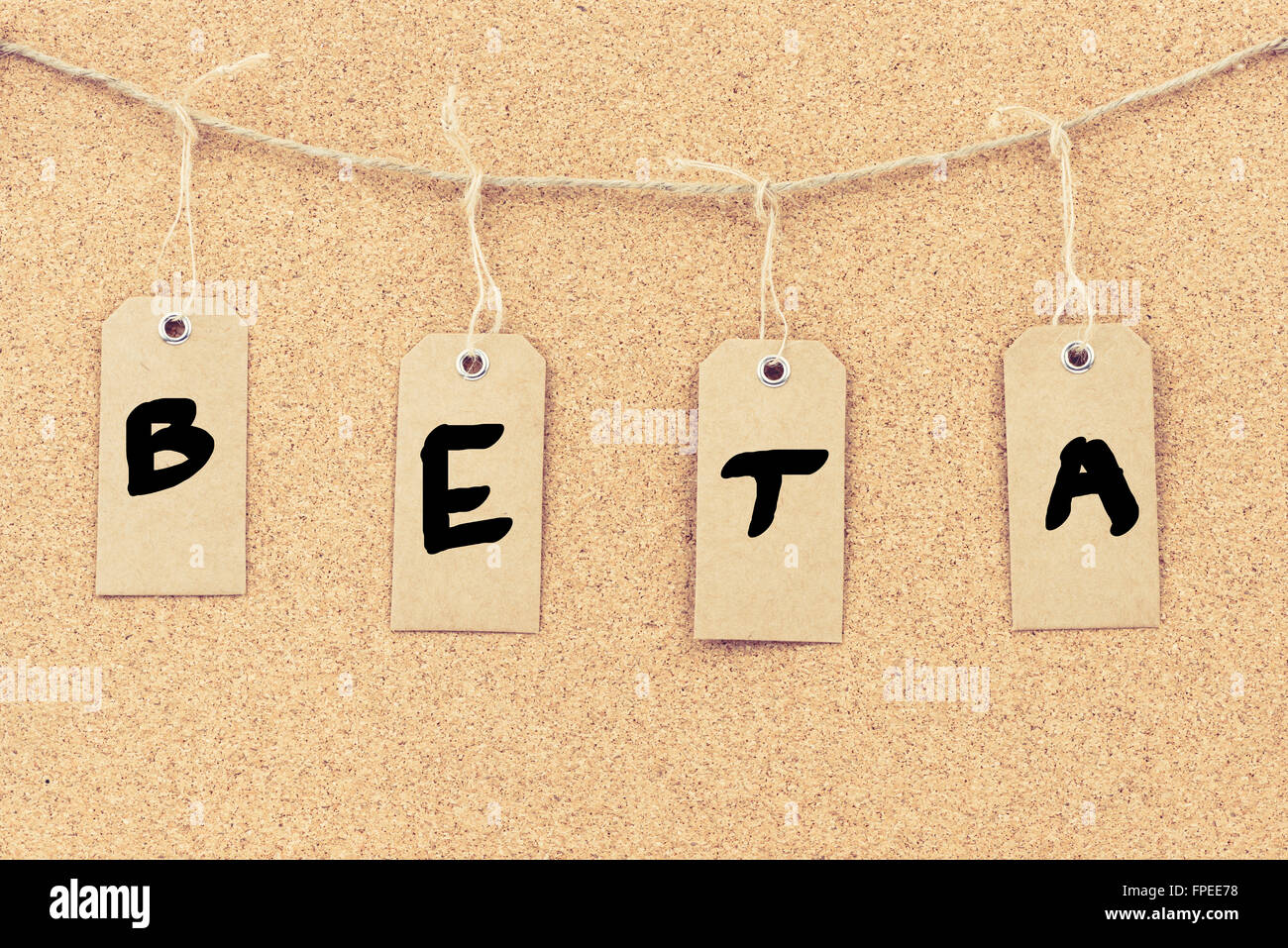 Vintage grunge tags with letters on rope string, word BETA over cork ...