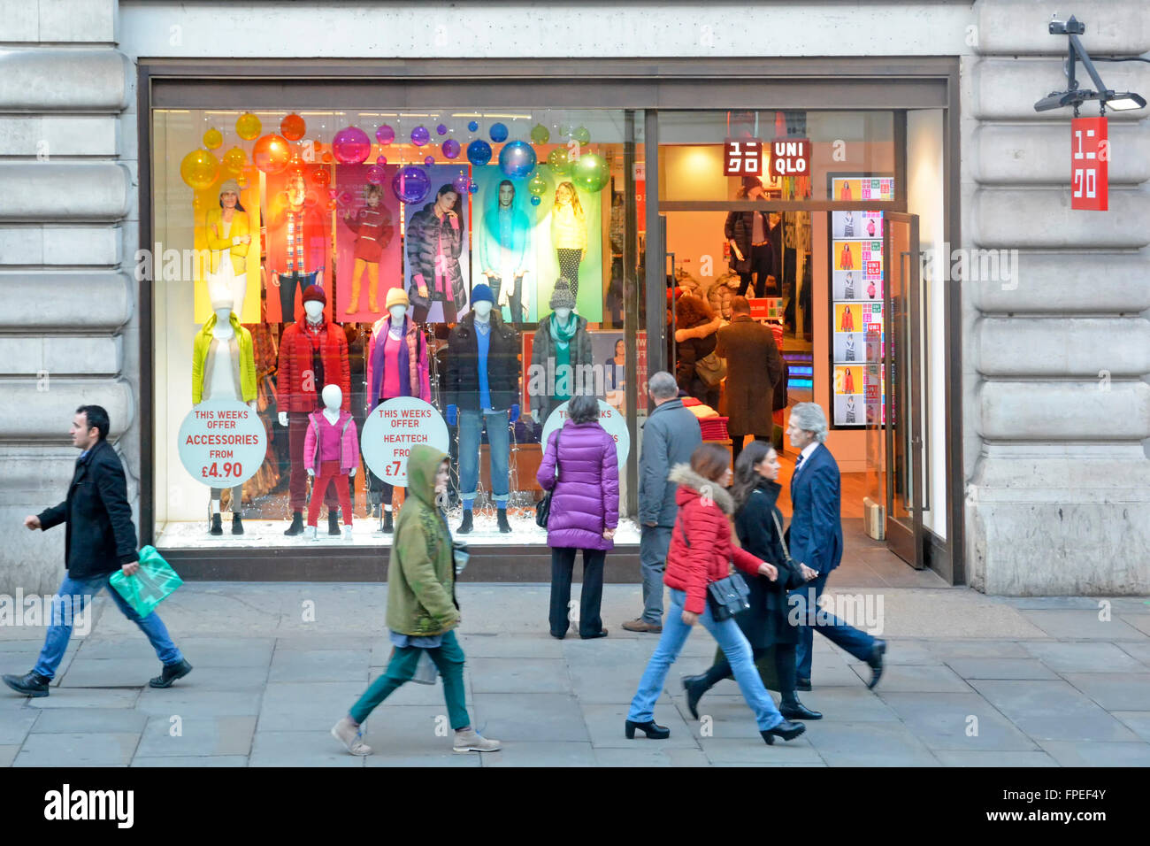 Looking down at shoppers outside colourful winter shop front window ...