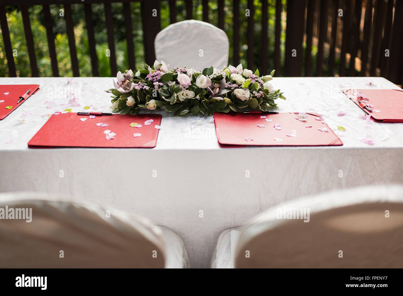 Wedding solemnisation ceremony with table top decorated with flowers ...
