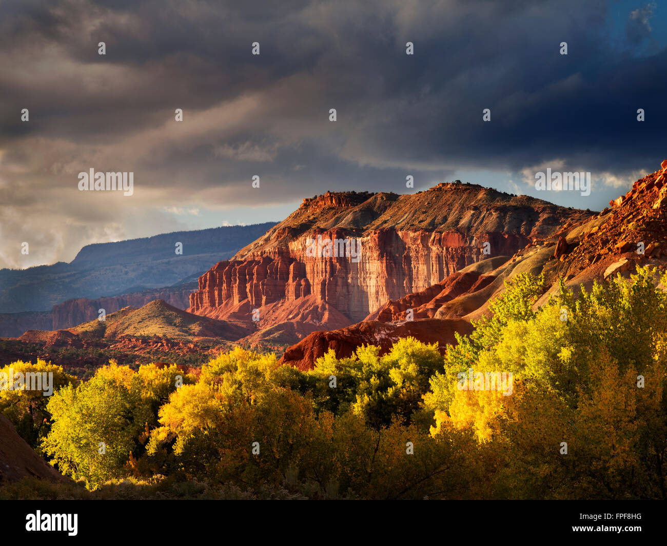 Fall colored Cottonwood Trees and rock formations with storm clouds ...