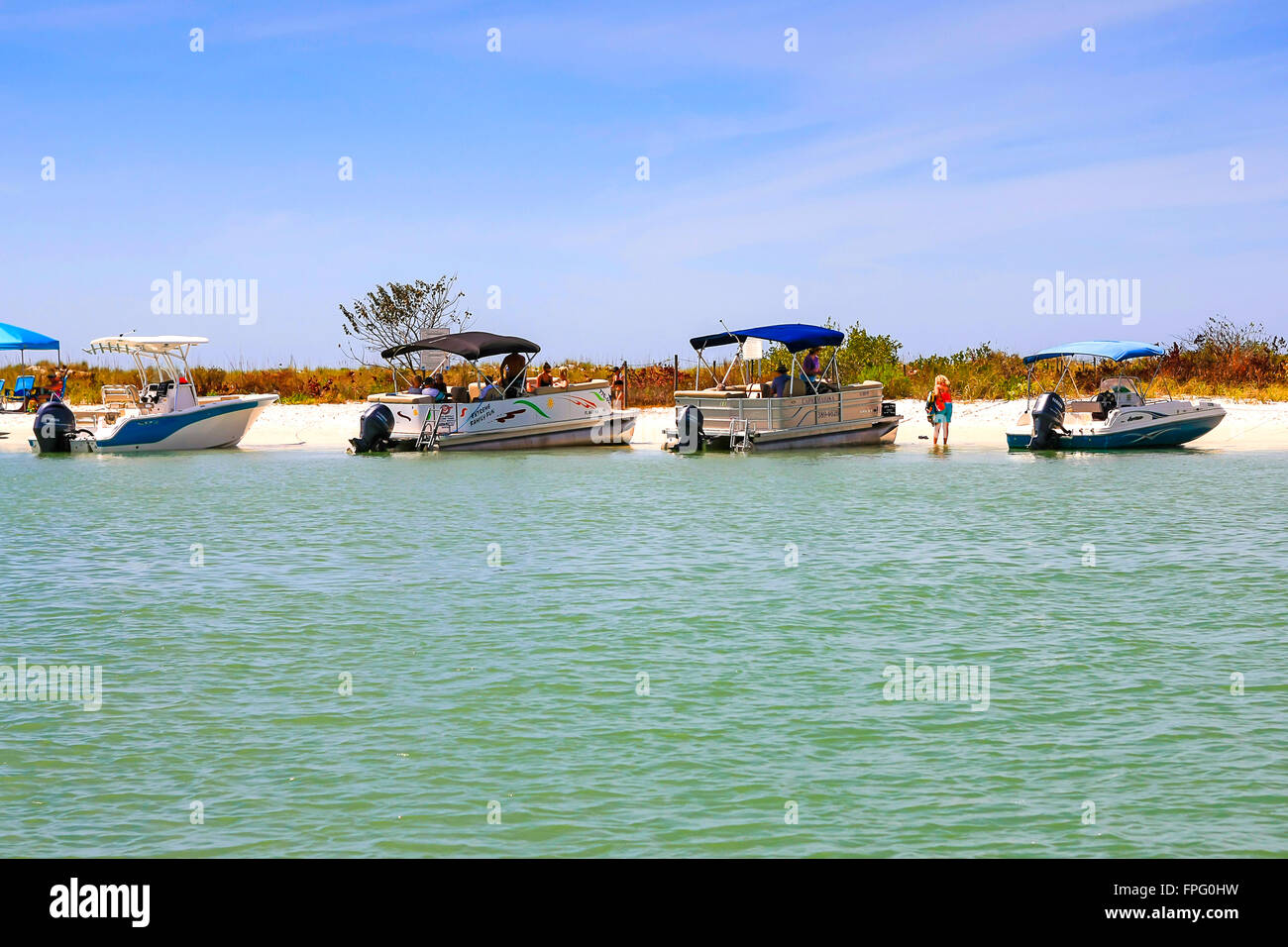 People and their boats having fun in the sun around Keewaydin Island ...