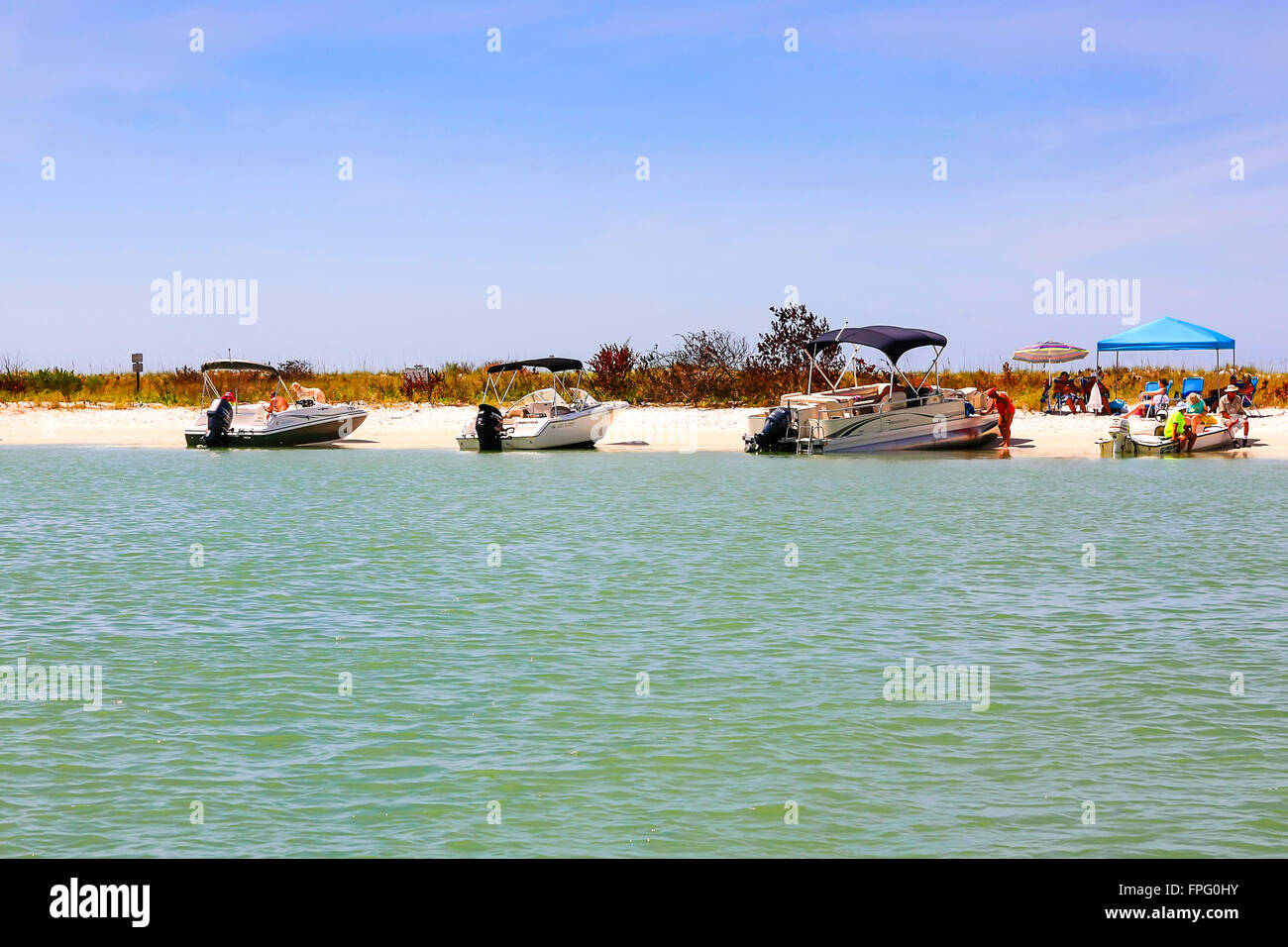 People and their boats having fun in the sun around Keewaydin Island ...
