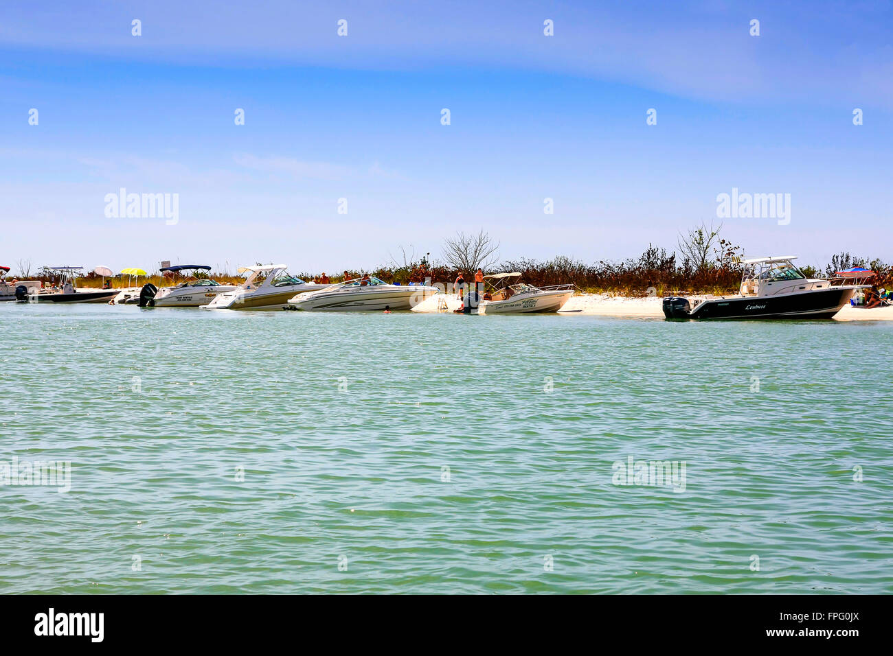 People and their boats having fun in the sun around Keewaydin Island ...