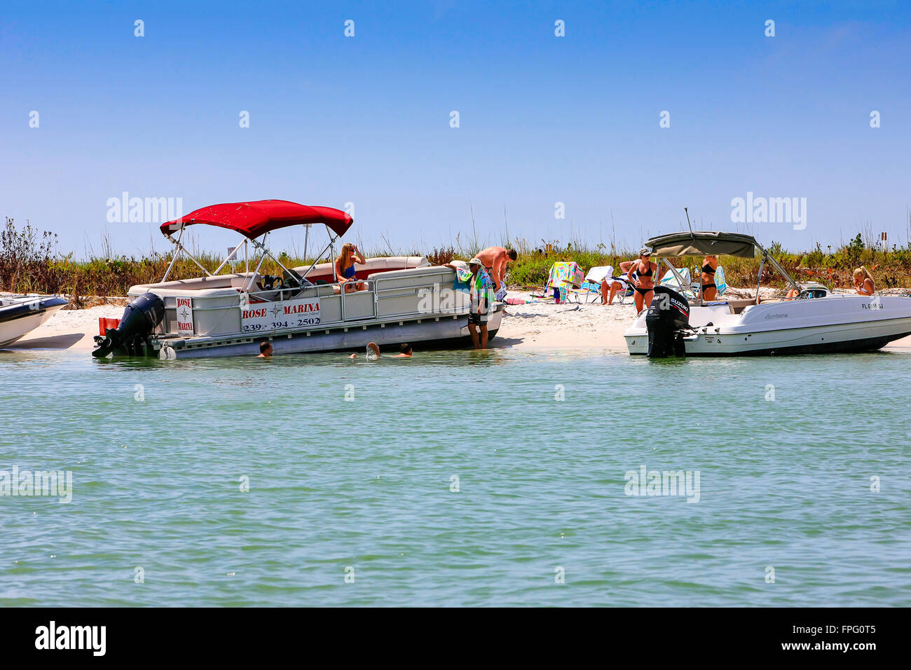 People and their boats having fun in the sun around Keewaydin Island ...