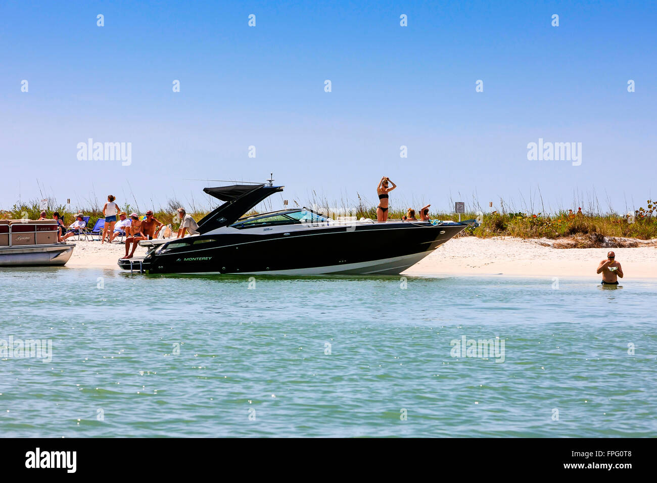People and their boats having fun in the sun around Keewaydin Island ...