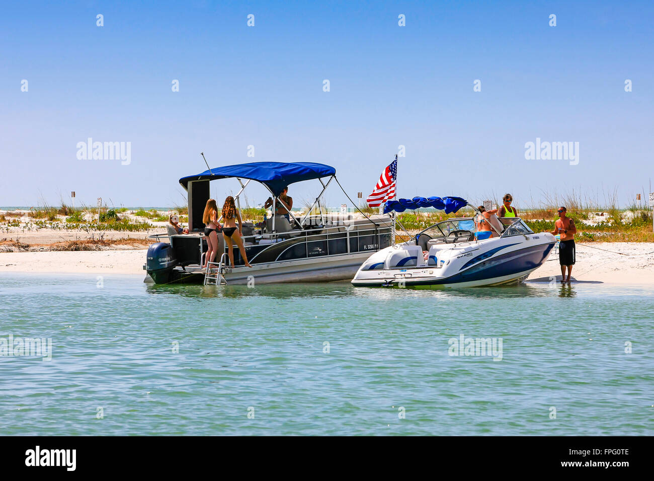 People and their boats having fun in the sun around Keewaydin Island ...