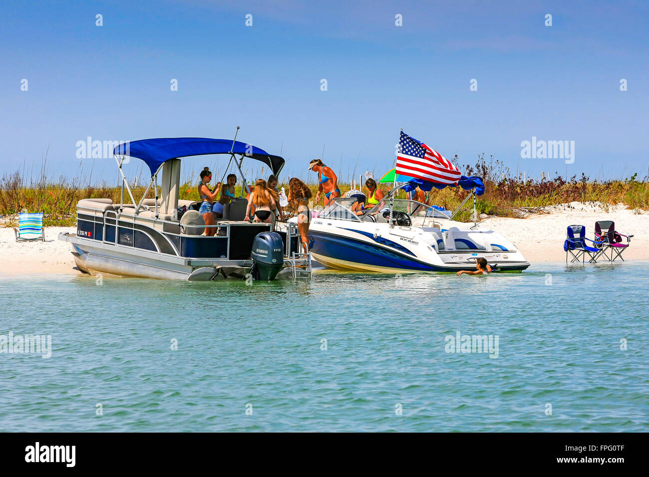 People and their boats having fun in the sun around Keewaydin Island ...