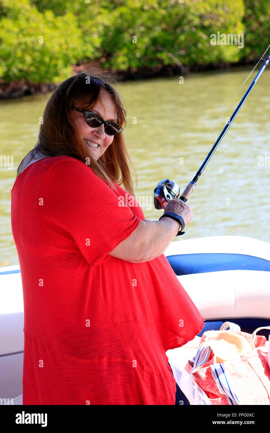 Adult woman trying her hand at a spot of fishing in Florida Stock Photo ...