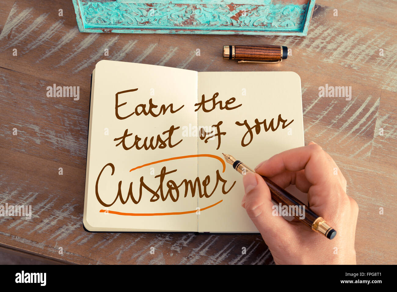 Handwritten text EARN THE TRUST OF YOUR CUSTOMER, business success ...