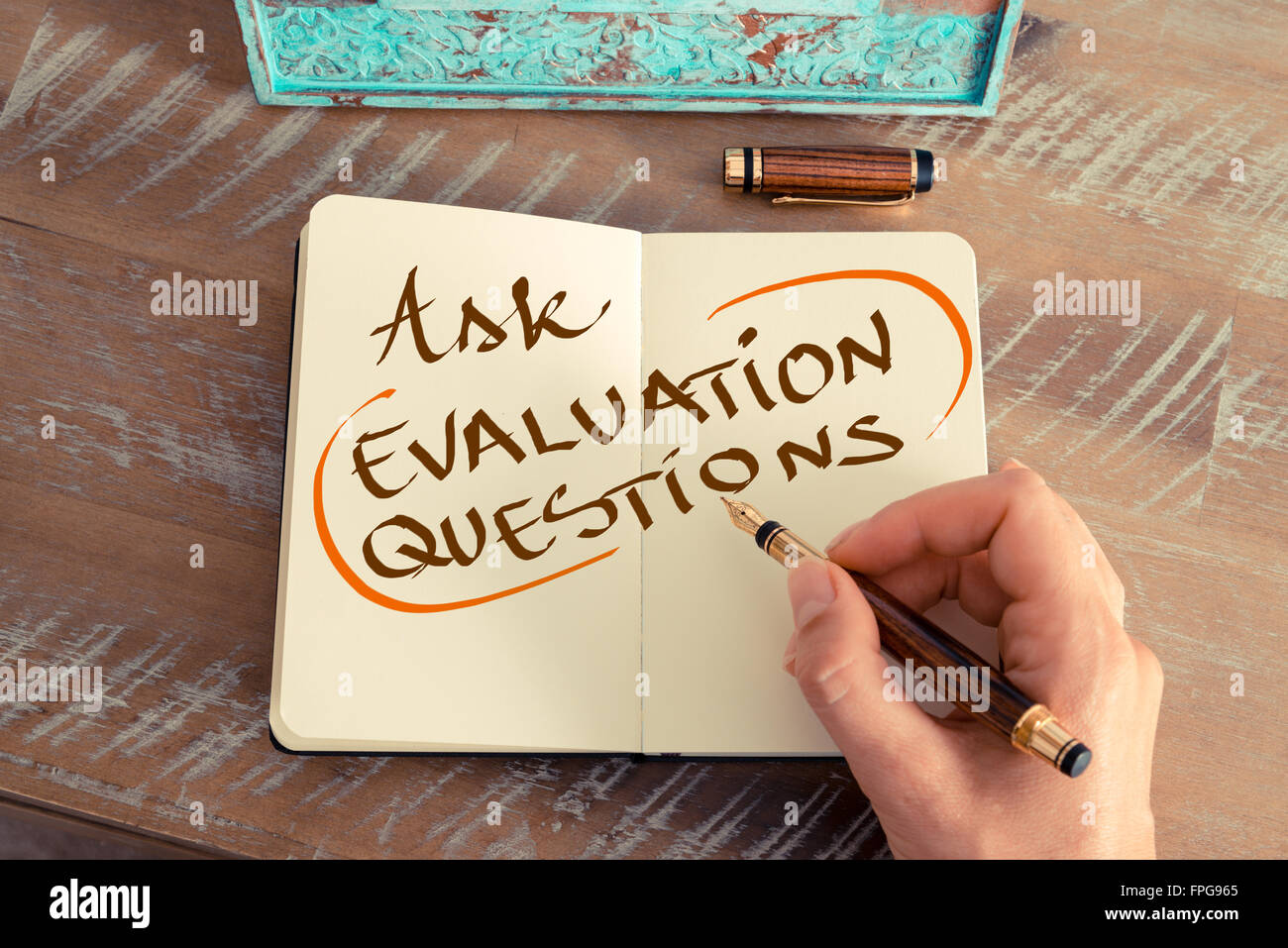 Handwritten text ASK EVALUATION QUESTIONS, business success concept ...
