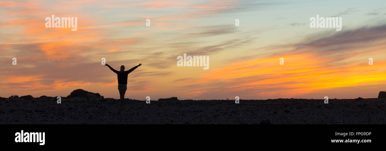 Woman enjoying freedom at sunset Stock Photo - Alamy