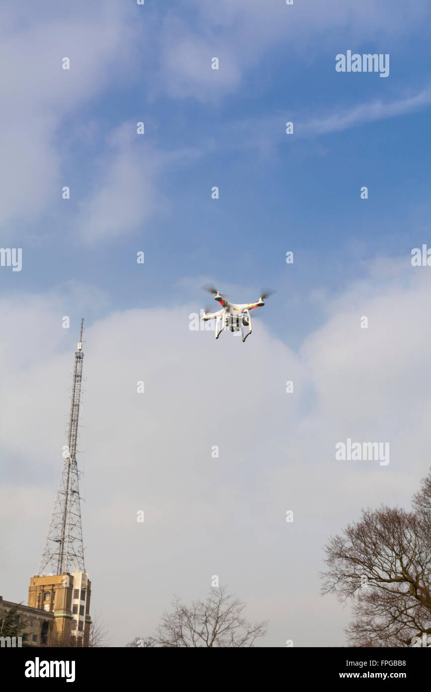 Quadcopter drone in the sky hovering in front of the BBC transmission ...