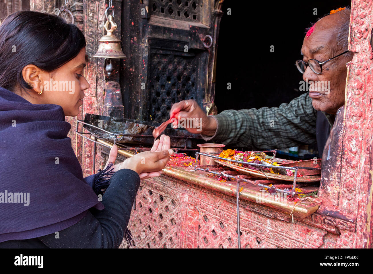 Nepal, Patan. Female Worshiper Receiving Red Kumkuma (Sindoor) Powder ...